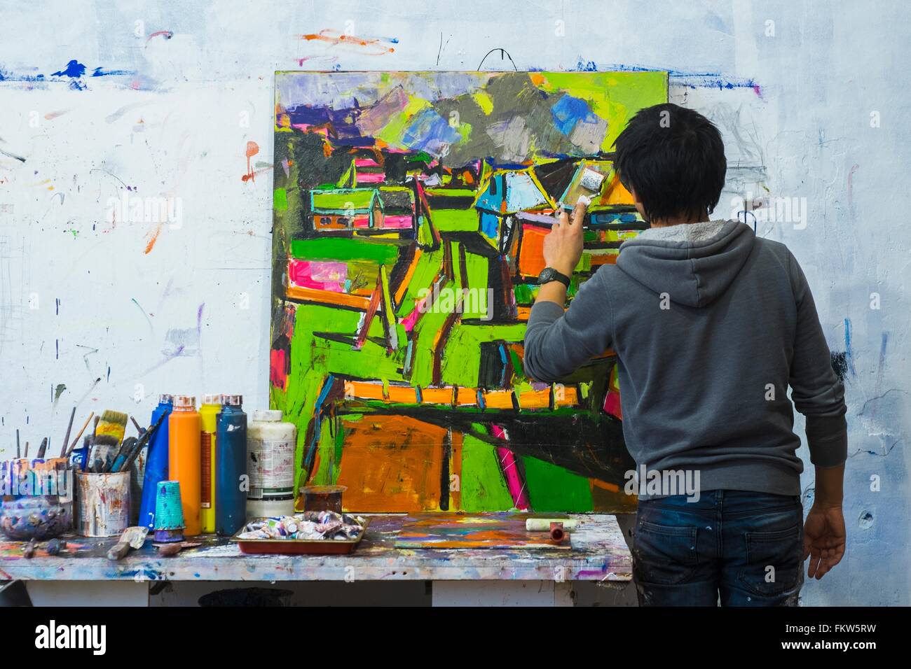 Artist painting on canvas Stock Photo - Alamy
