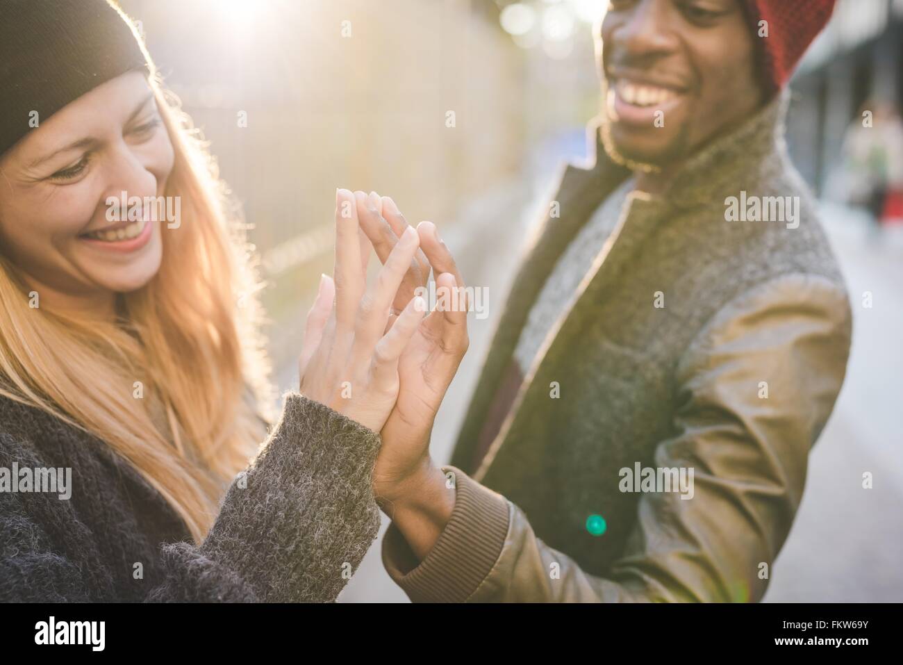 Couple doing high five Stock Photo - Alamy