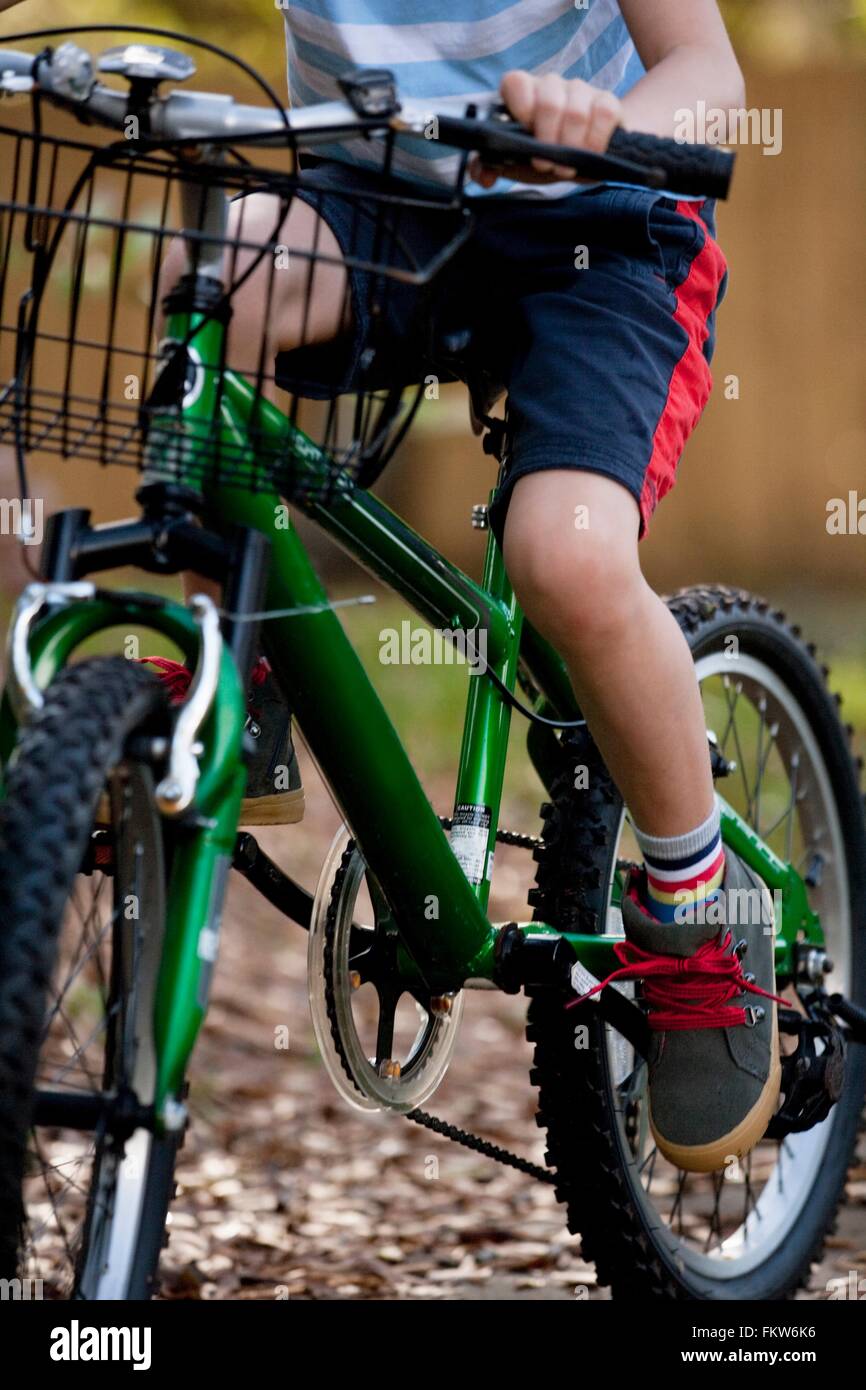 Boy riding bicycle Stock Photo - Alamy