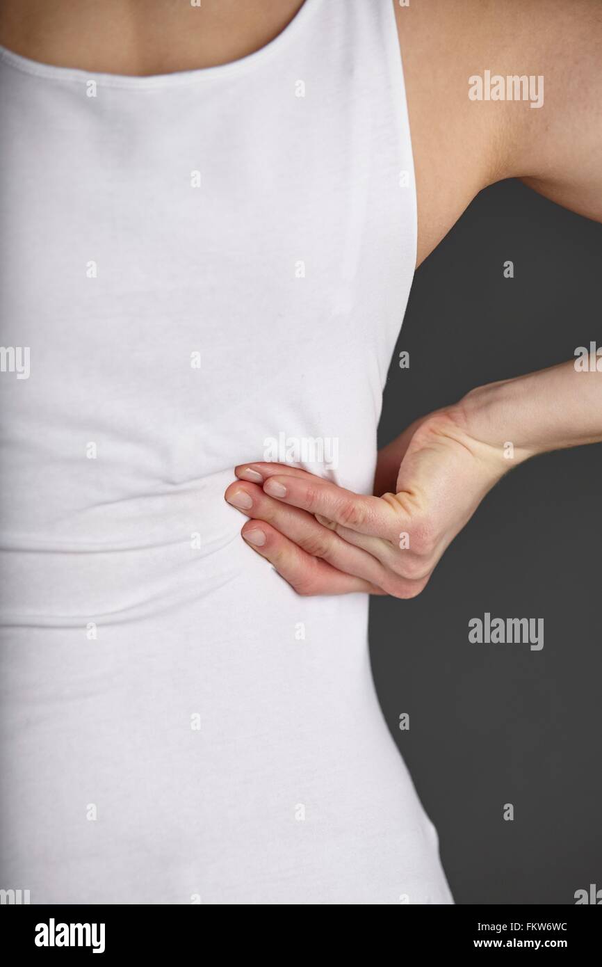 Cropped shot of young womans hand massaging her own back Stock Photo ...