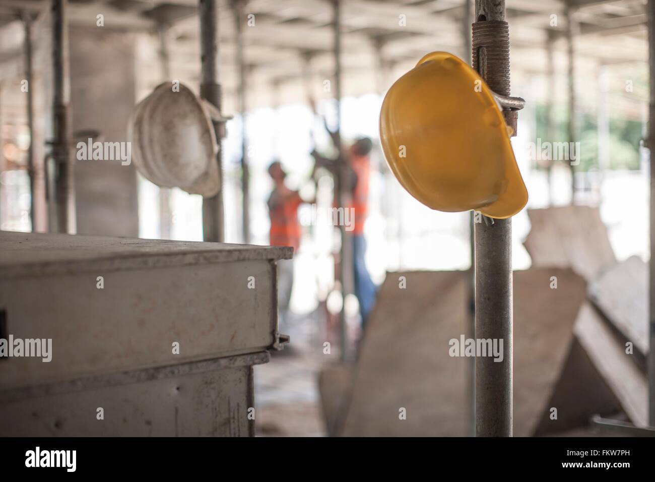 Male builders working on scaffolding on construction site Stock Photo ...