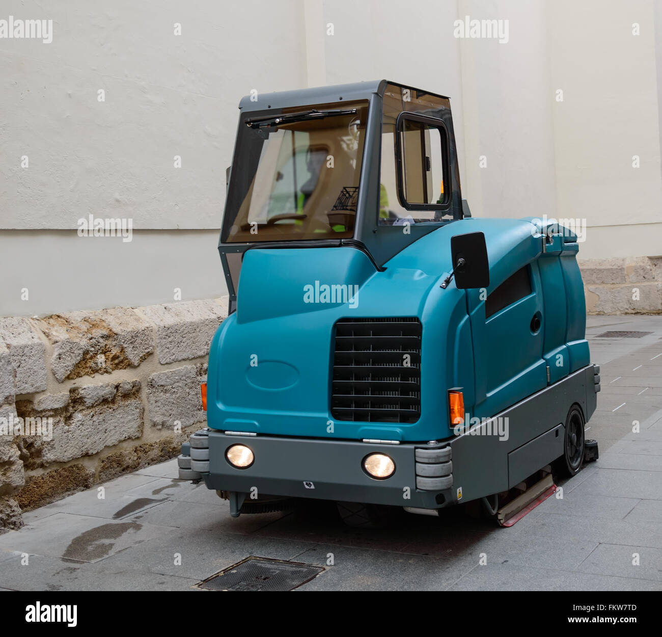 Street cleaning machine in the process of street washing Stock Photo ...