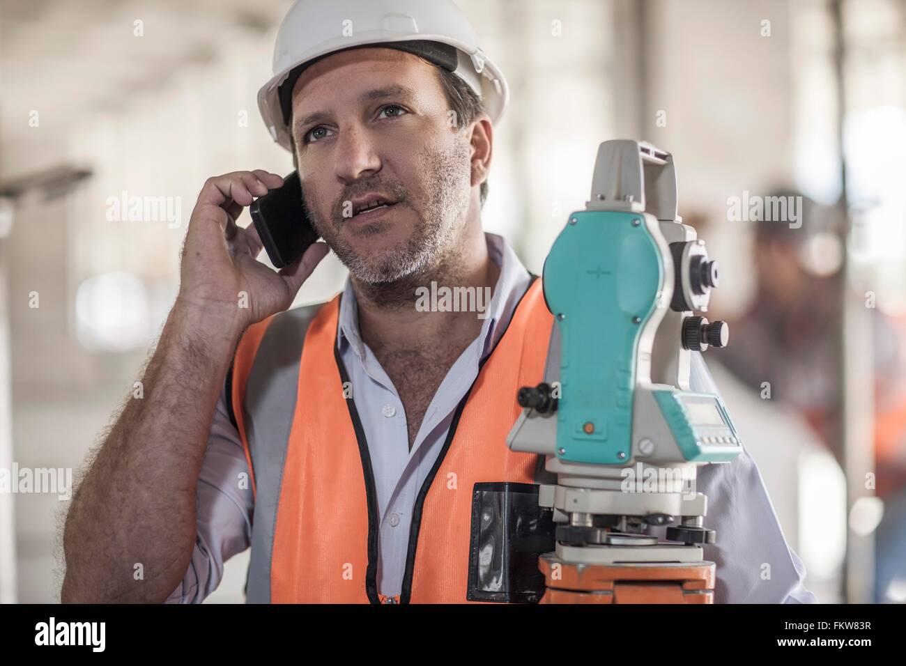 Surveyor in hard hat using surveying hi-res stock photography and ...