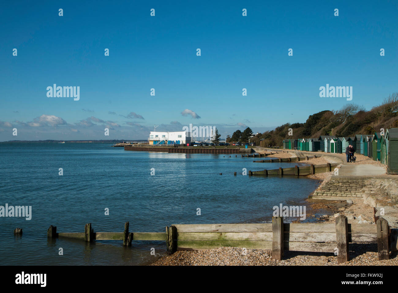 Meon Shore, Hampshire at full tide with Beach Huts to the right ...