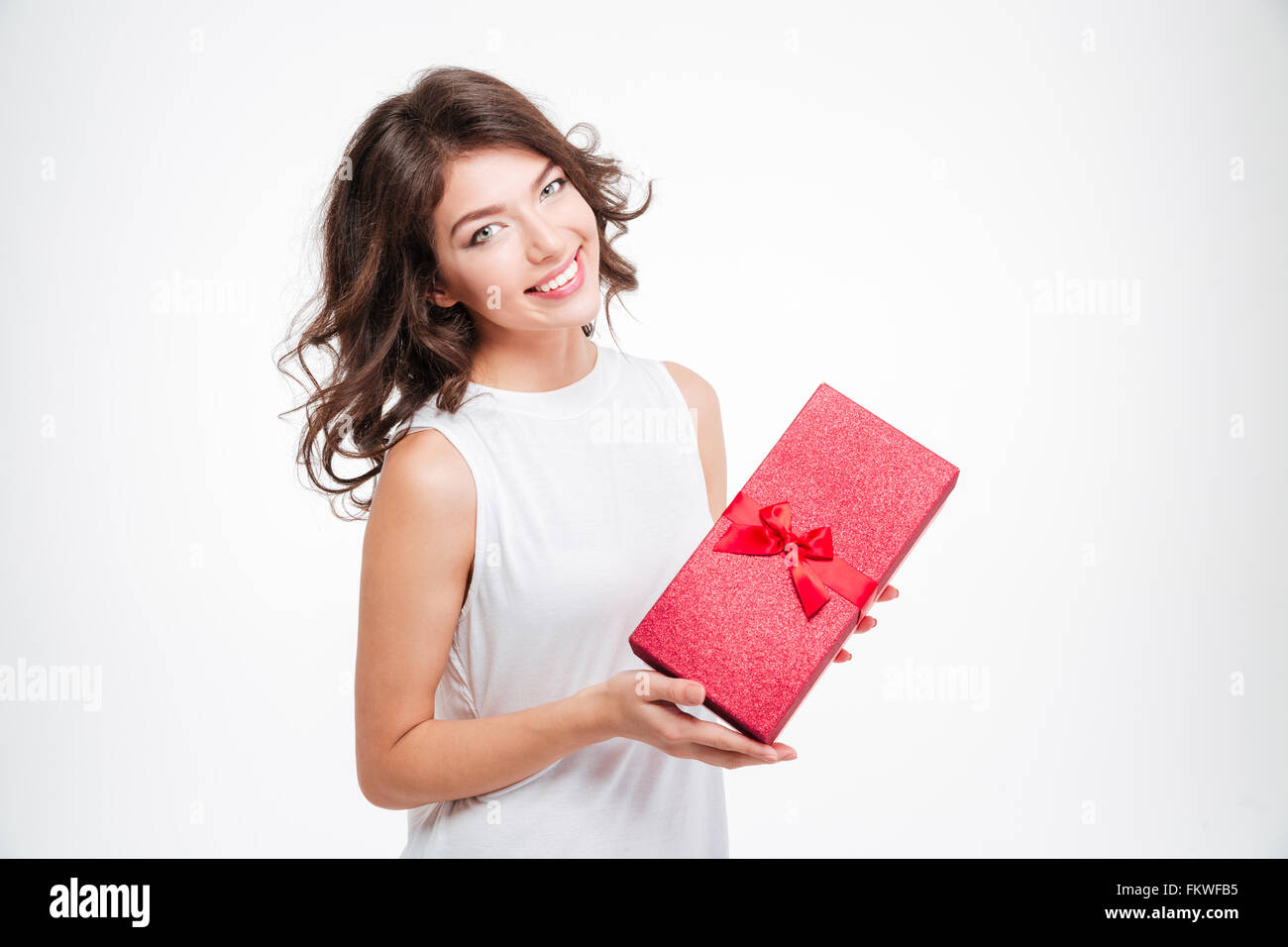 Portrait of a happy cute woman holding gift box isolated on a white ...