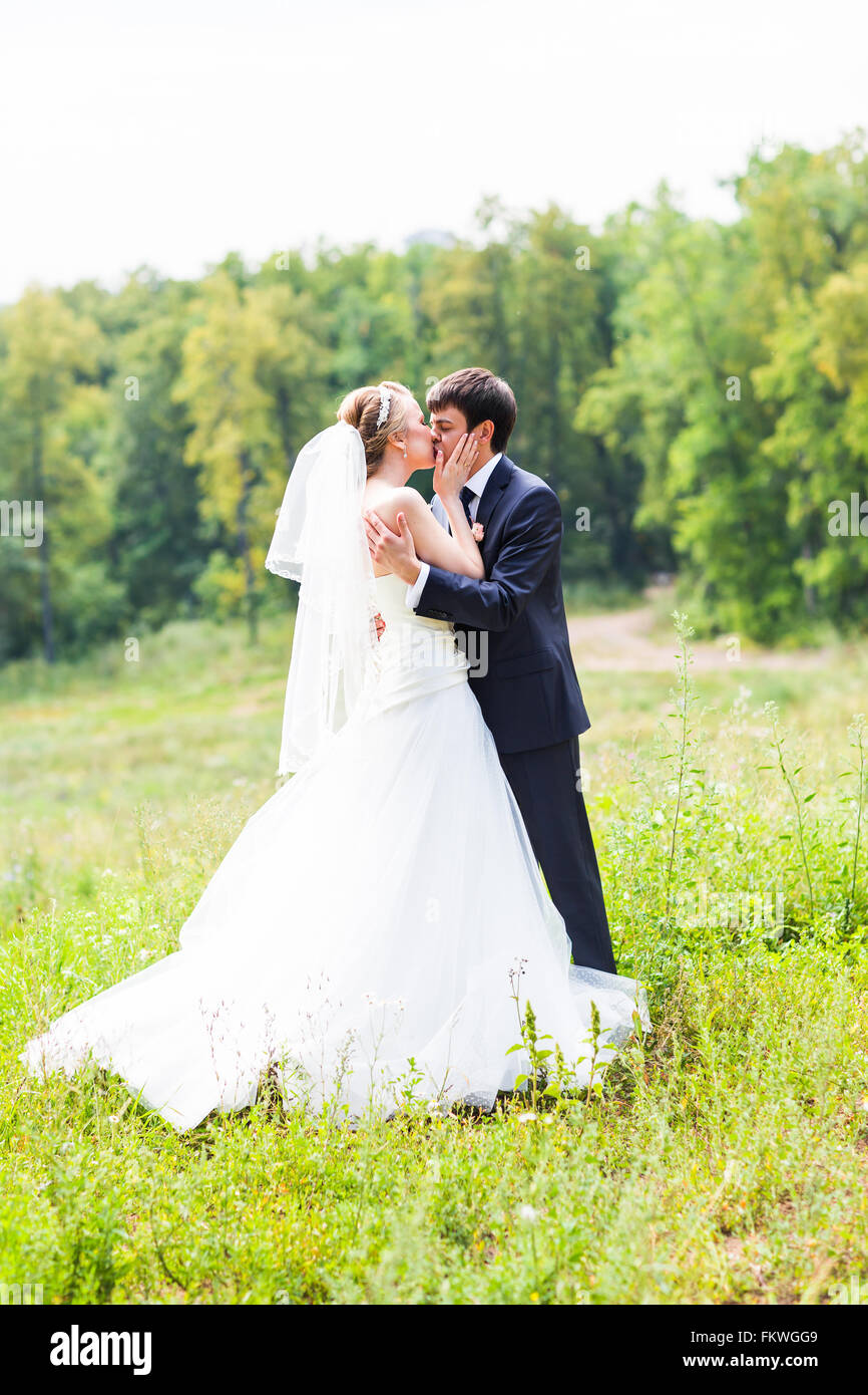 Wedding, Beautiful Romantic Bride and Groom Kissing Stock Photo - Alamy