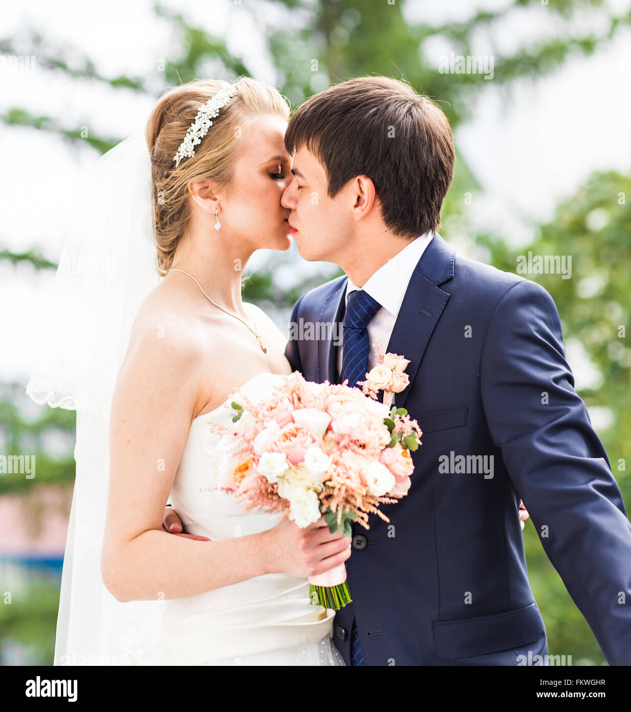 Wedding, Beautiful Romantic Bride and Groom Kissing Stock Photo - Alamy
