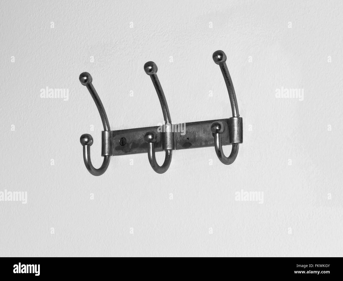 Rusted metallic hanger on a white wall. Horizontal Stock Photo - Alamy