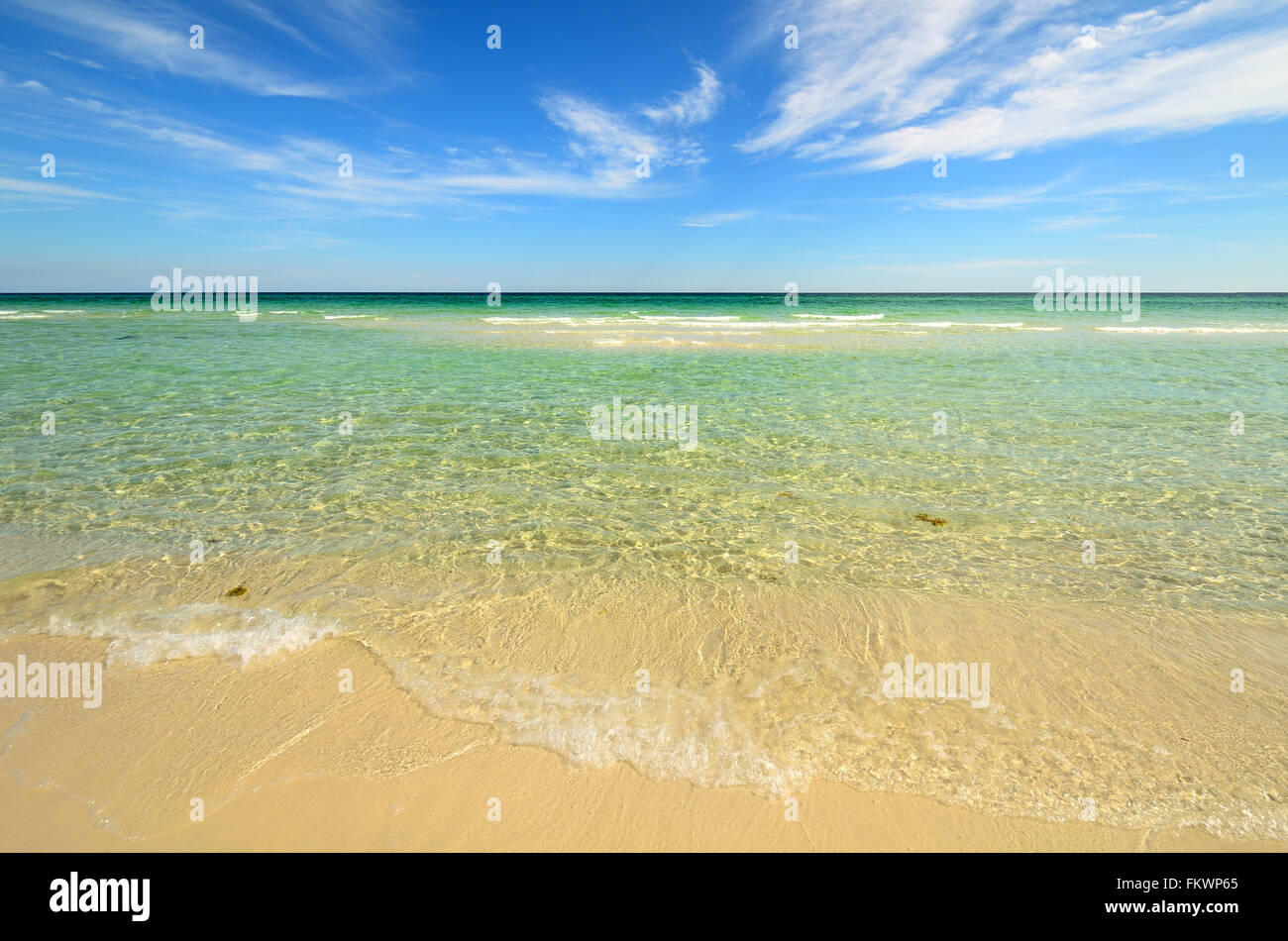 Tropical paradise beach with bright yellow sand and crystal clear green ...