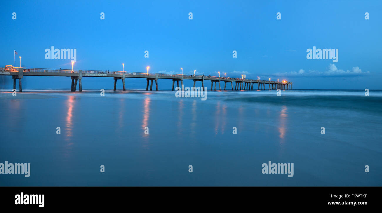 Long pier during twilight in blue tones with some city lights Stock ...