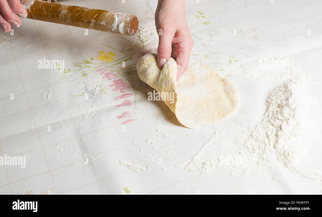 Making dough by female hands on white table background Stock Photo - Alamy