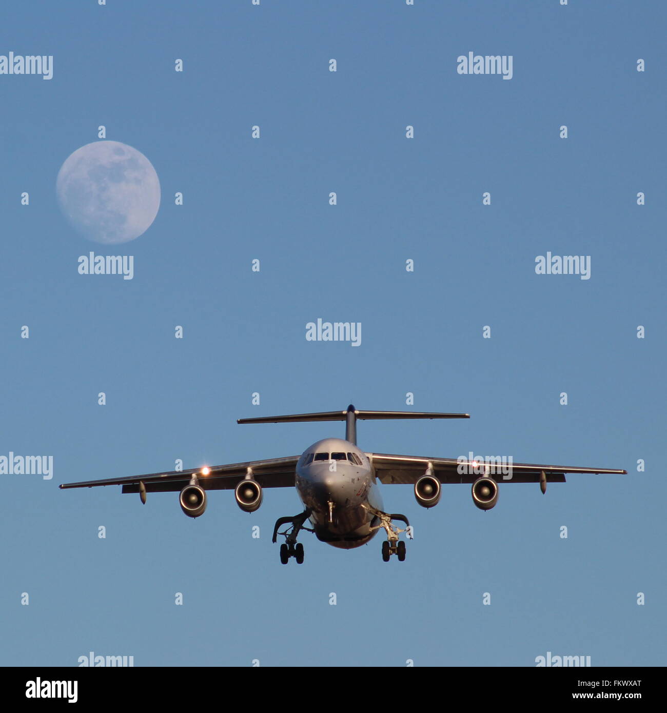 Plane Landing at London Heathrow Airport with moon in background Stock ...