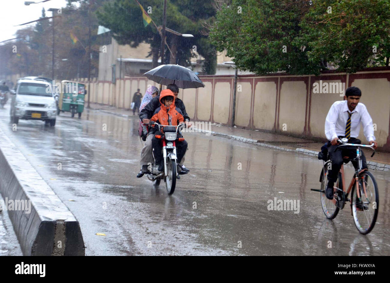 Commuters pass through rain water hi-res stock photography and images ...