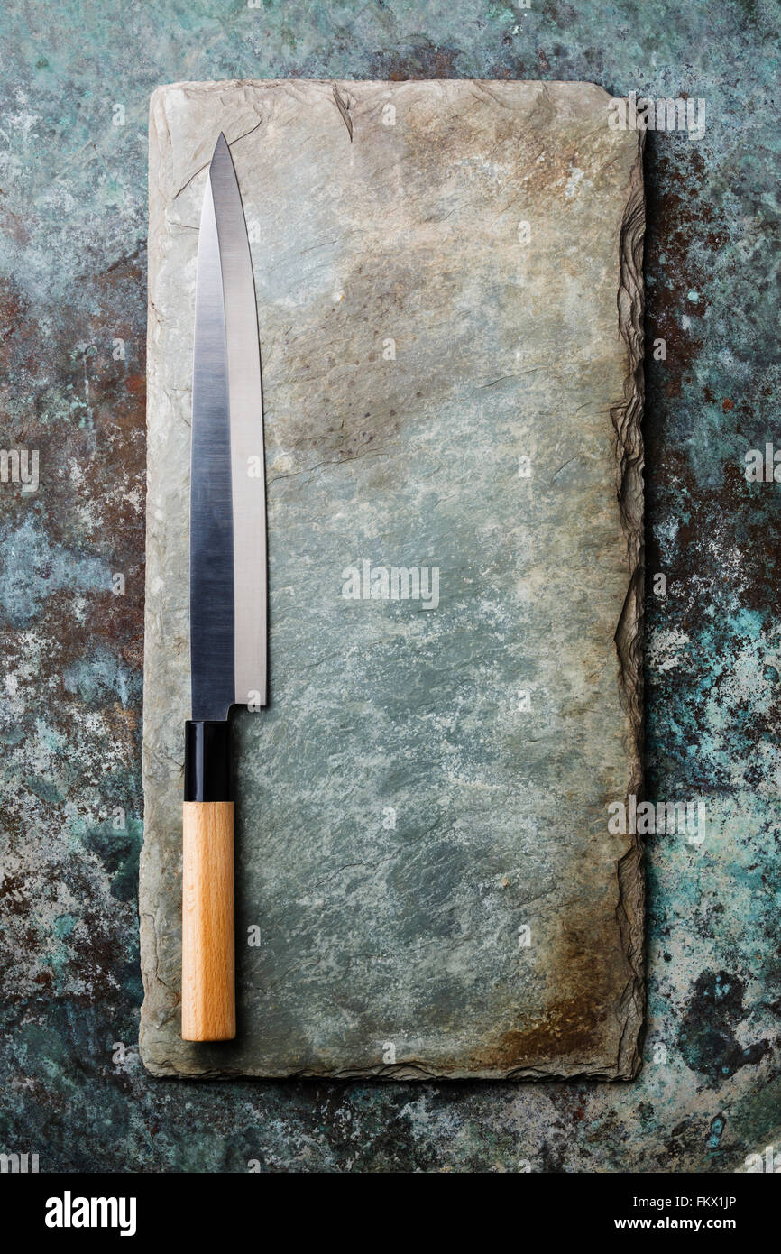 Japanese sashimi knife on gray stone slate background texture Stock ...