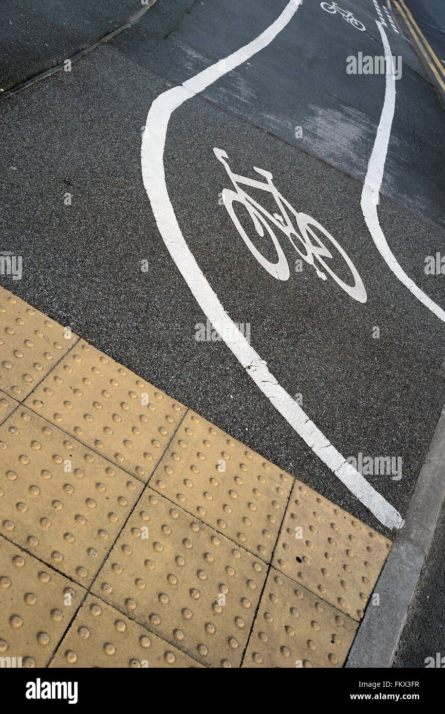 Tactile paving and cycle lane markings at a road junction Stock Photo ...
