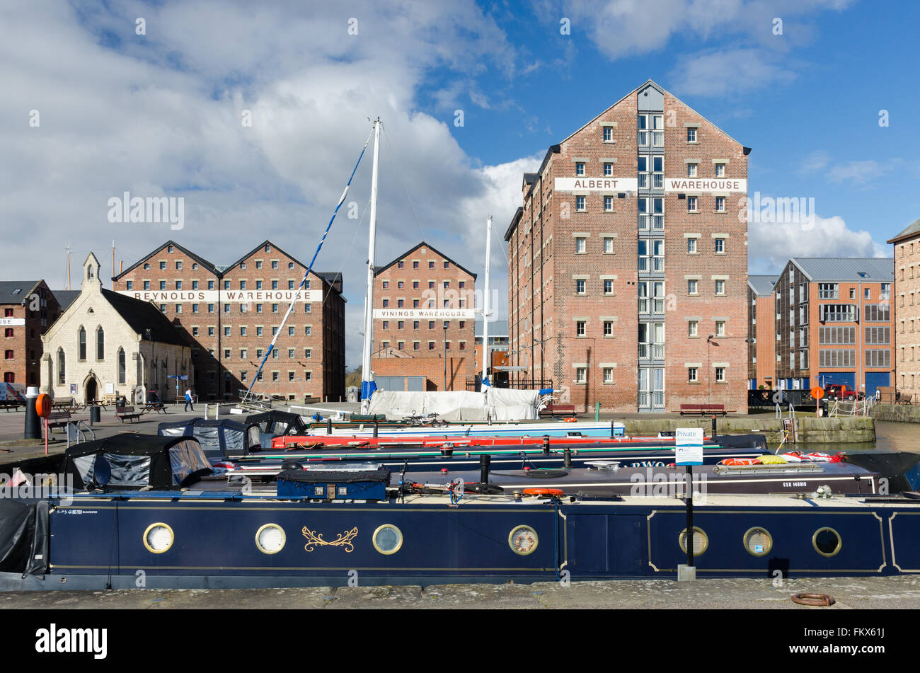Narrow boats moored in front of converted warehouses at Gloucester ...
