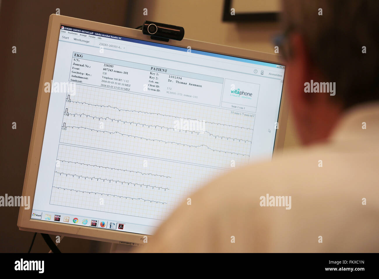 Telephysician Thomas Assmann looks at the electrocardiogram (ECG) data ...