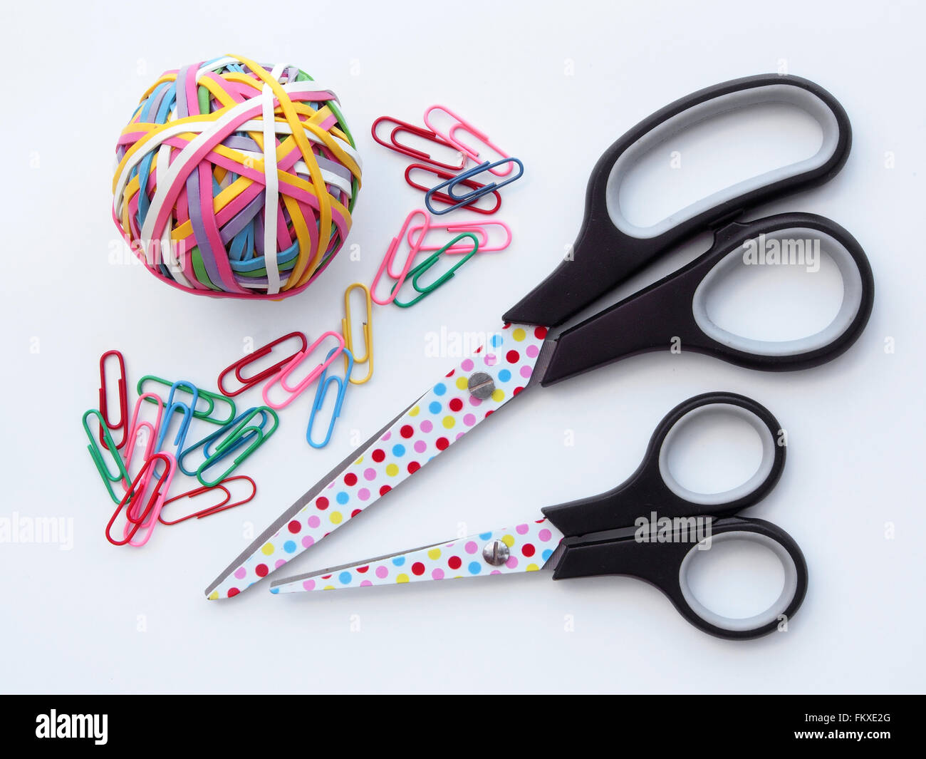 Collection of stationery, scissors, paperclips and elastic bands on a ...