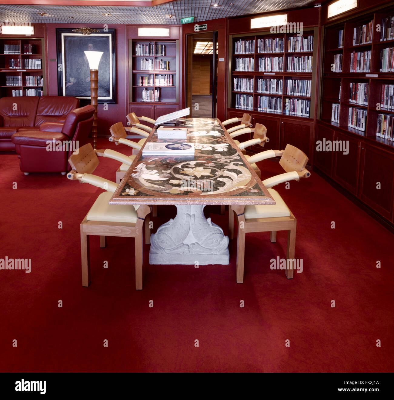 Classical library room with leather armchairs, stone table and World ...