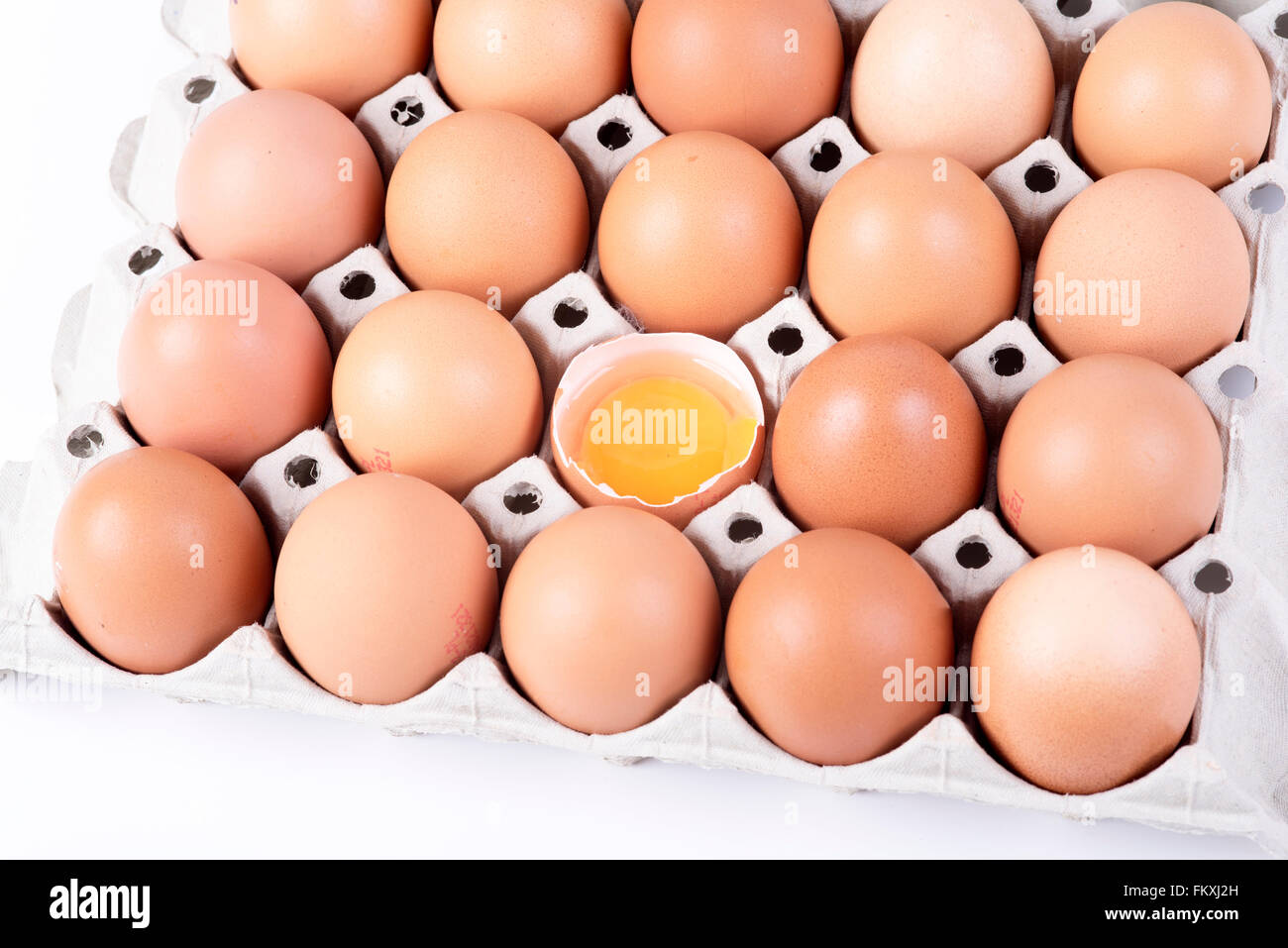 broken egg in a container with egg yolk Stock Photo - Alamy