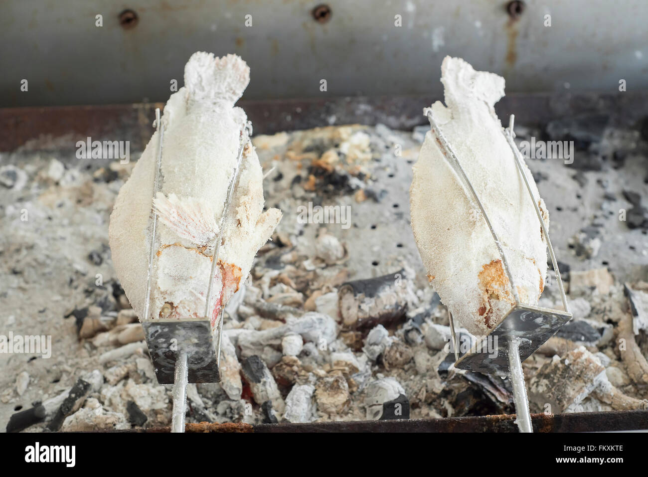 Salt coated grilled fish Stock Photo - Alamy