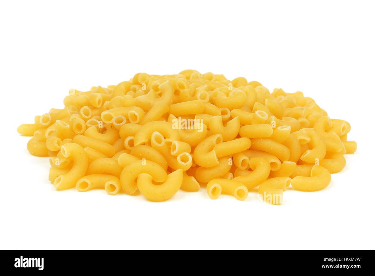 Pile of uncooked dry macaroni pasta isolated on a white background ...