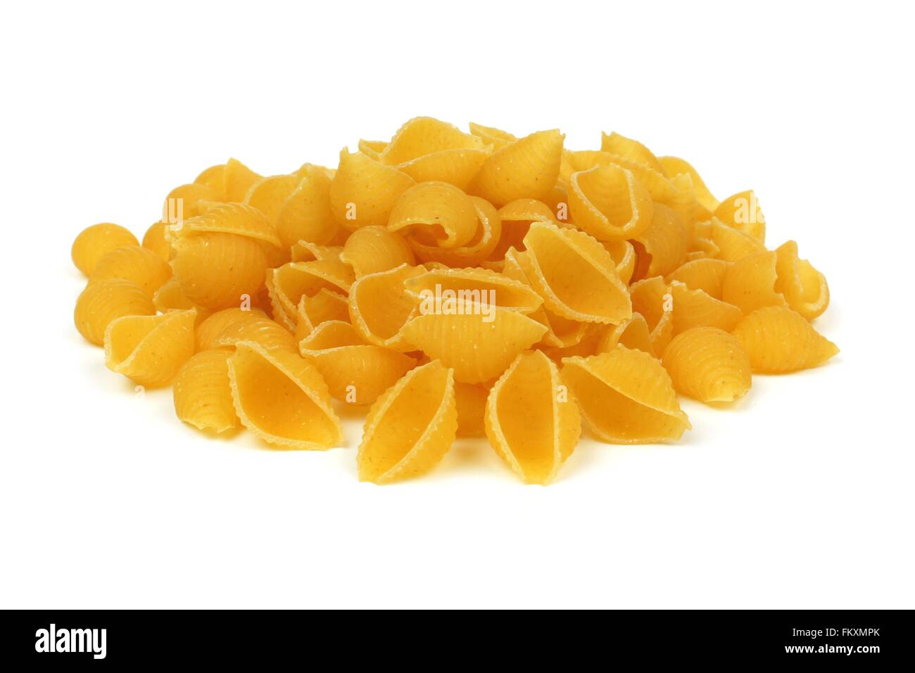 Pile of uncooked dry shell pasta isolated on a white background Stock ...