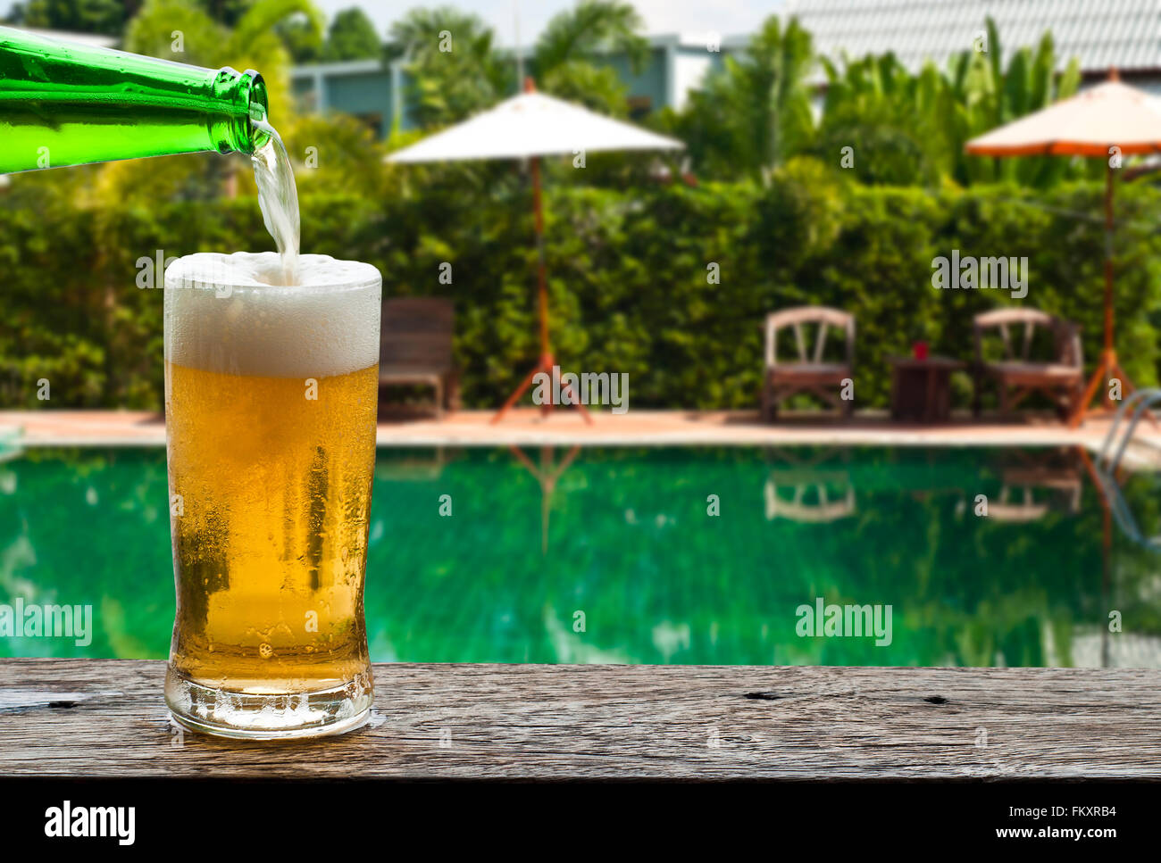 Enjoy beer beside swimming pool Stock Photo - Alamy