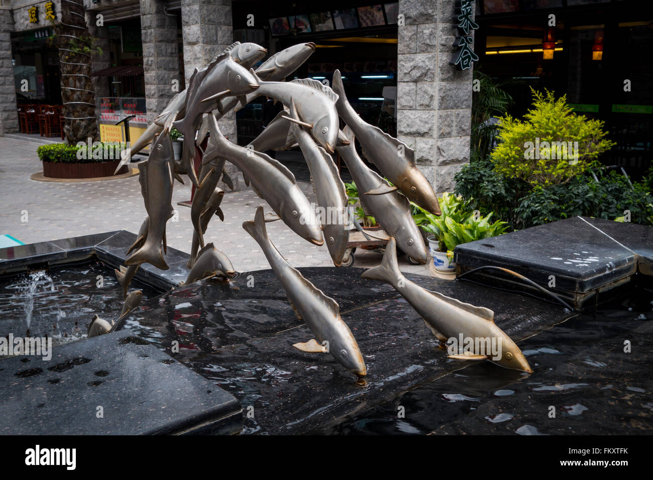 Fountain with flying fish. Hainan China Stock Photo - Alamy