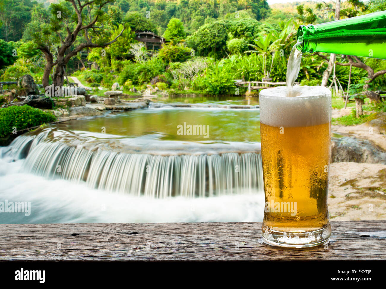Enjoy beer with waterfall landscape Stock Photo - Alamy