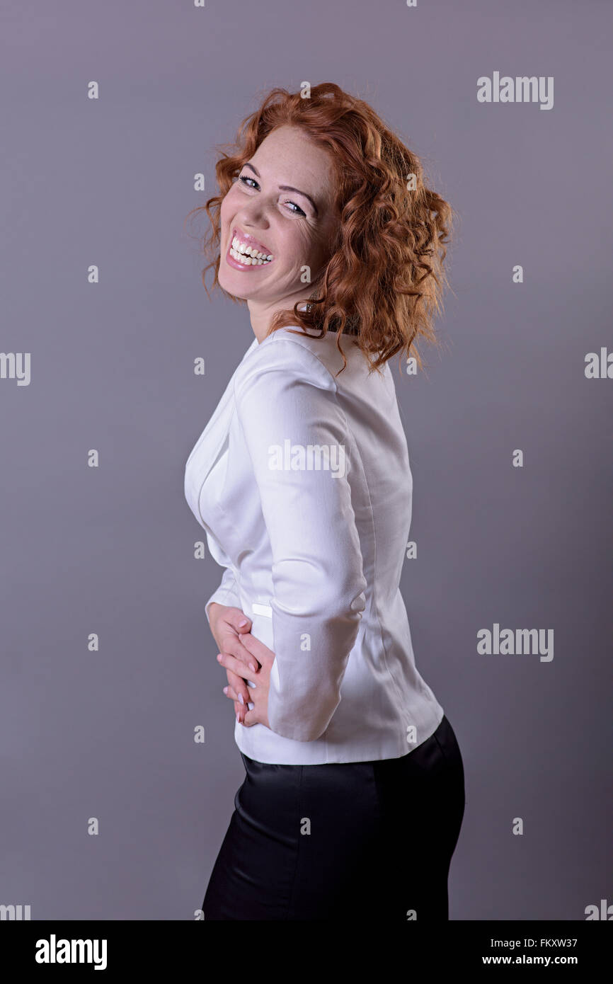Portrait of a pretty woman on a grey background Stock Photo - Alamy