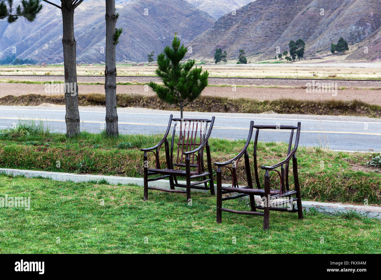 two wooden chairs near the highway Stock Photo - Alamy