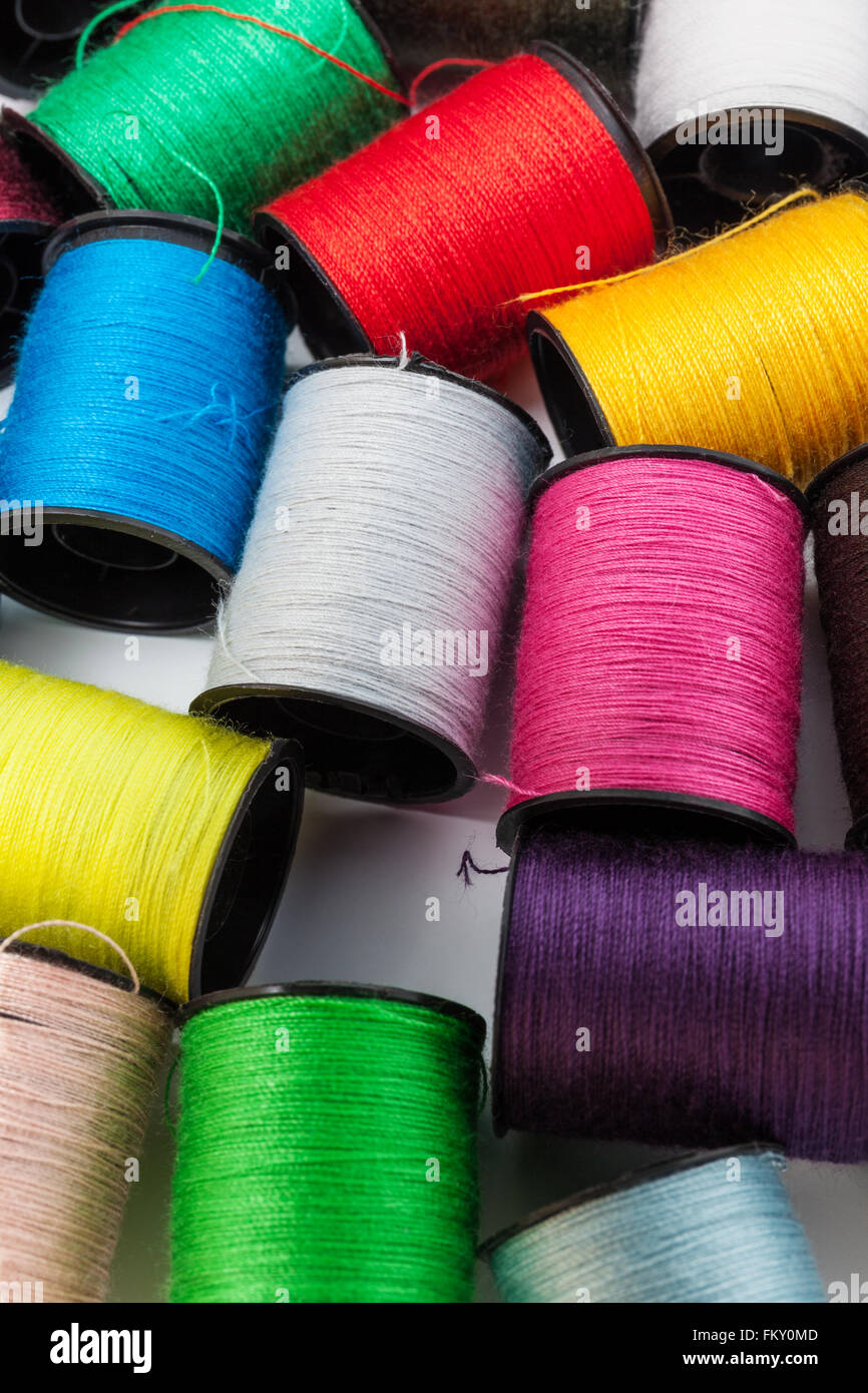 colorful threads on spools close up Stock Photo - Alamy