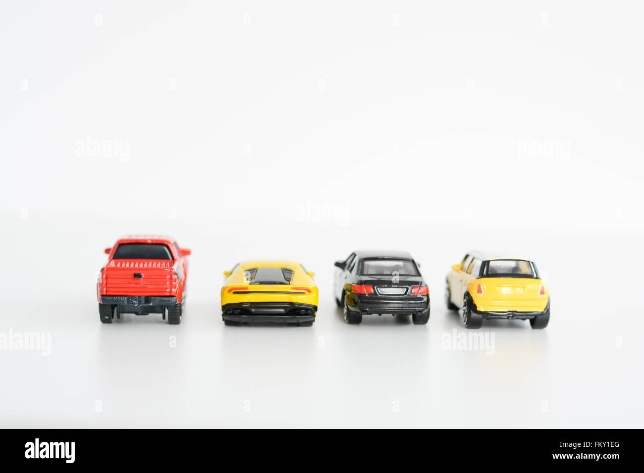 Many colorful car toys isolated on white background Stock Photo - Alamy