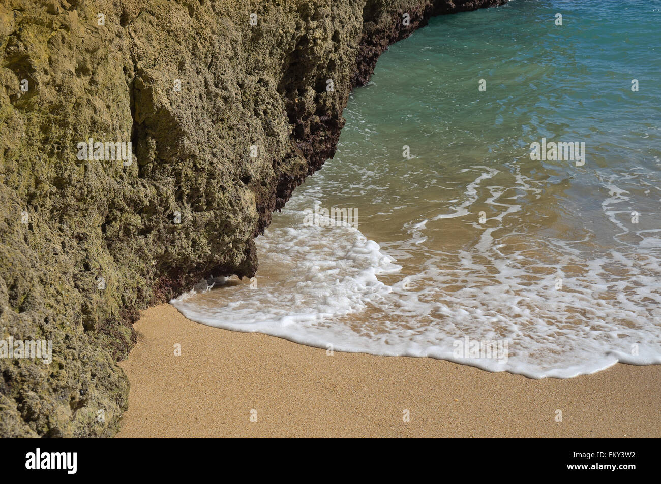 Water meets sand and cliff in Fontainhas beach. Algarve, Portugal Stock ...