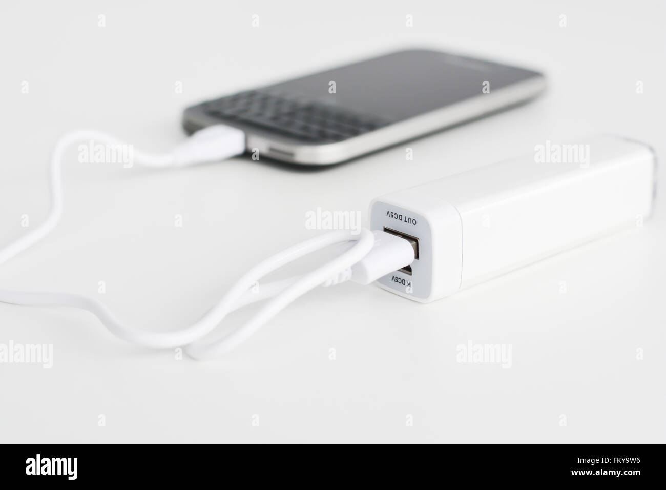 Mobile phone portable battery recharging a smartphone Stock Photo - Alamy