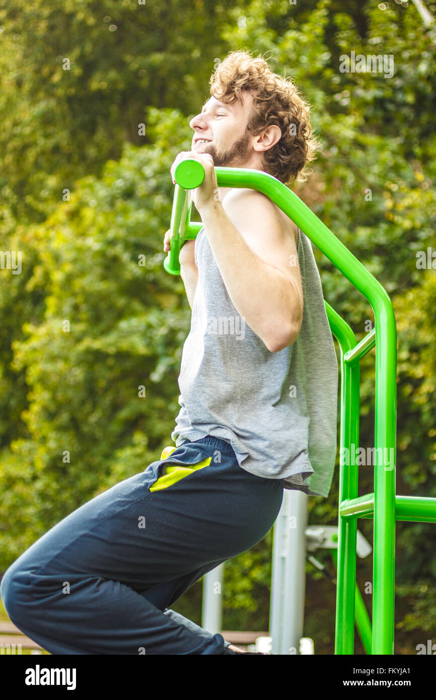 Active young man exercising on ladder. Muscular sporty guy in training ...