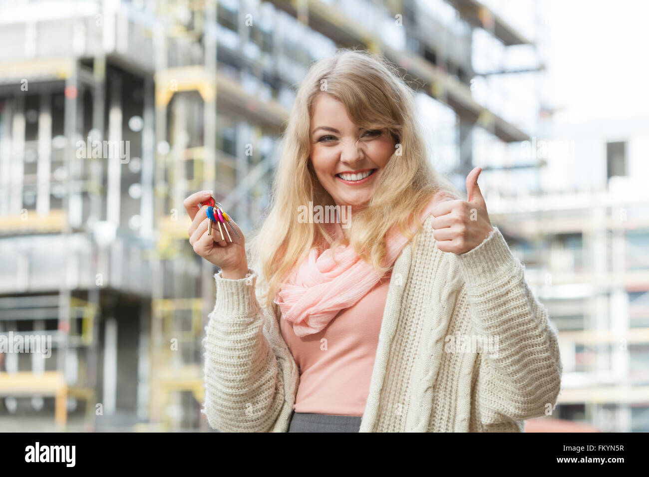 Real estate concept - young woman on front of new big modern house ...
