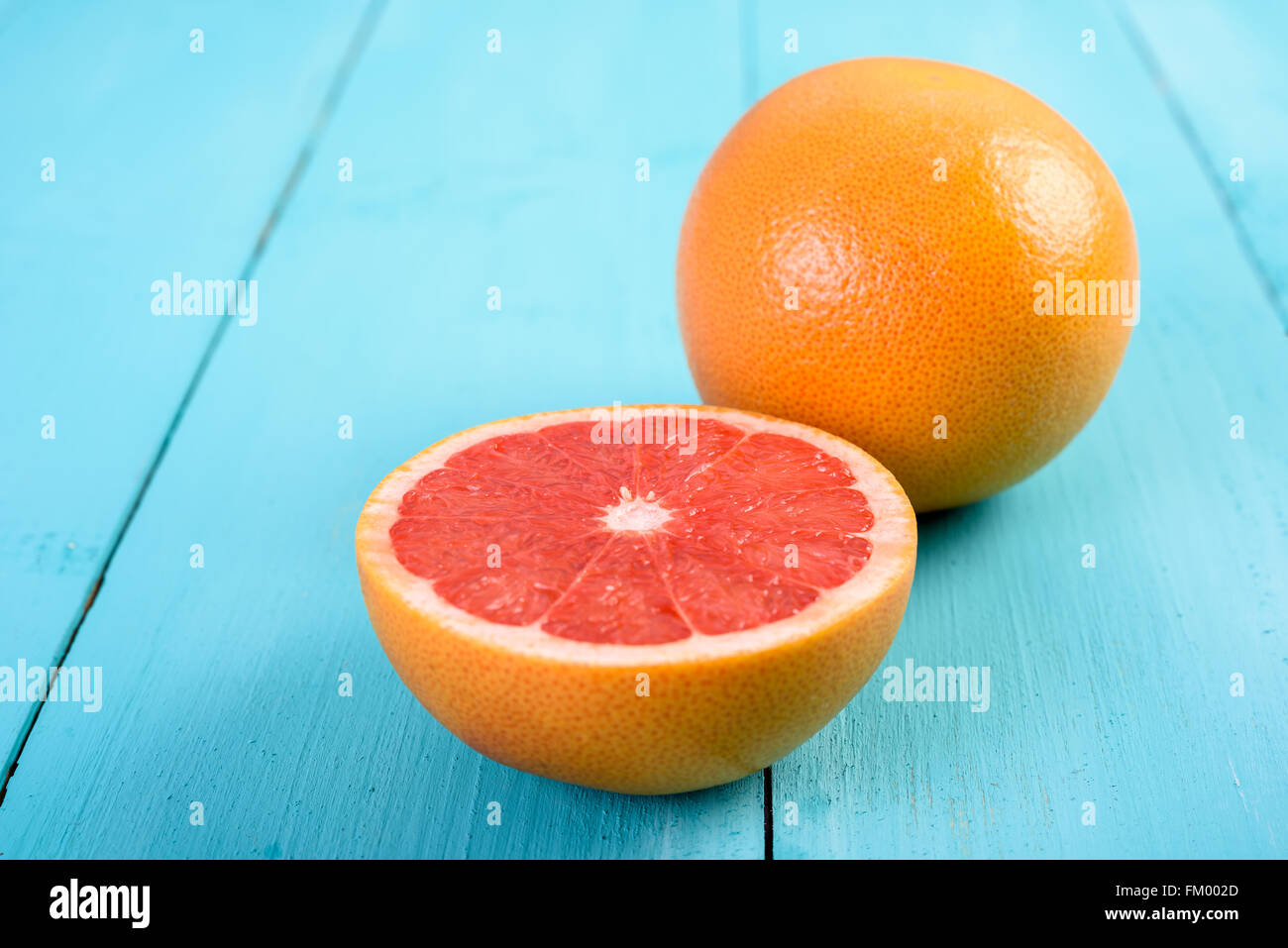 Fresh Red Grapefruit Slice On Wood Table Stock Photo - Alamy