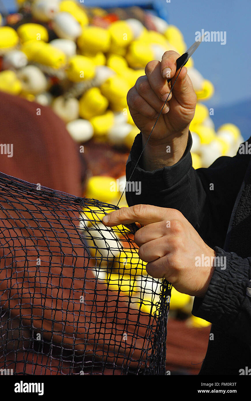 Man mending fishing nets hi-res stock photography and images - Alamy
