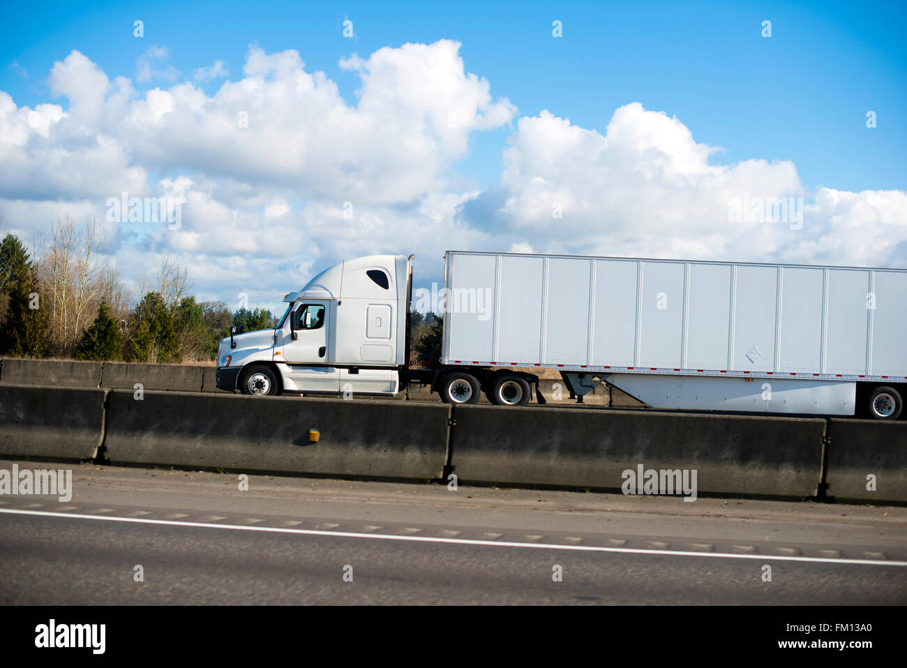 Modern aerodynamic big rig white semi-truck with a trailer in the ...