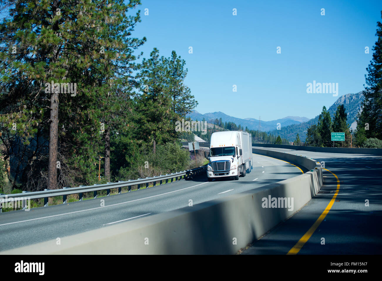 Fast and powerful heavy-lift modern white semi truck with a full size ...