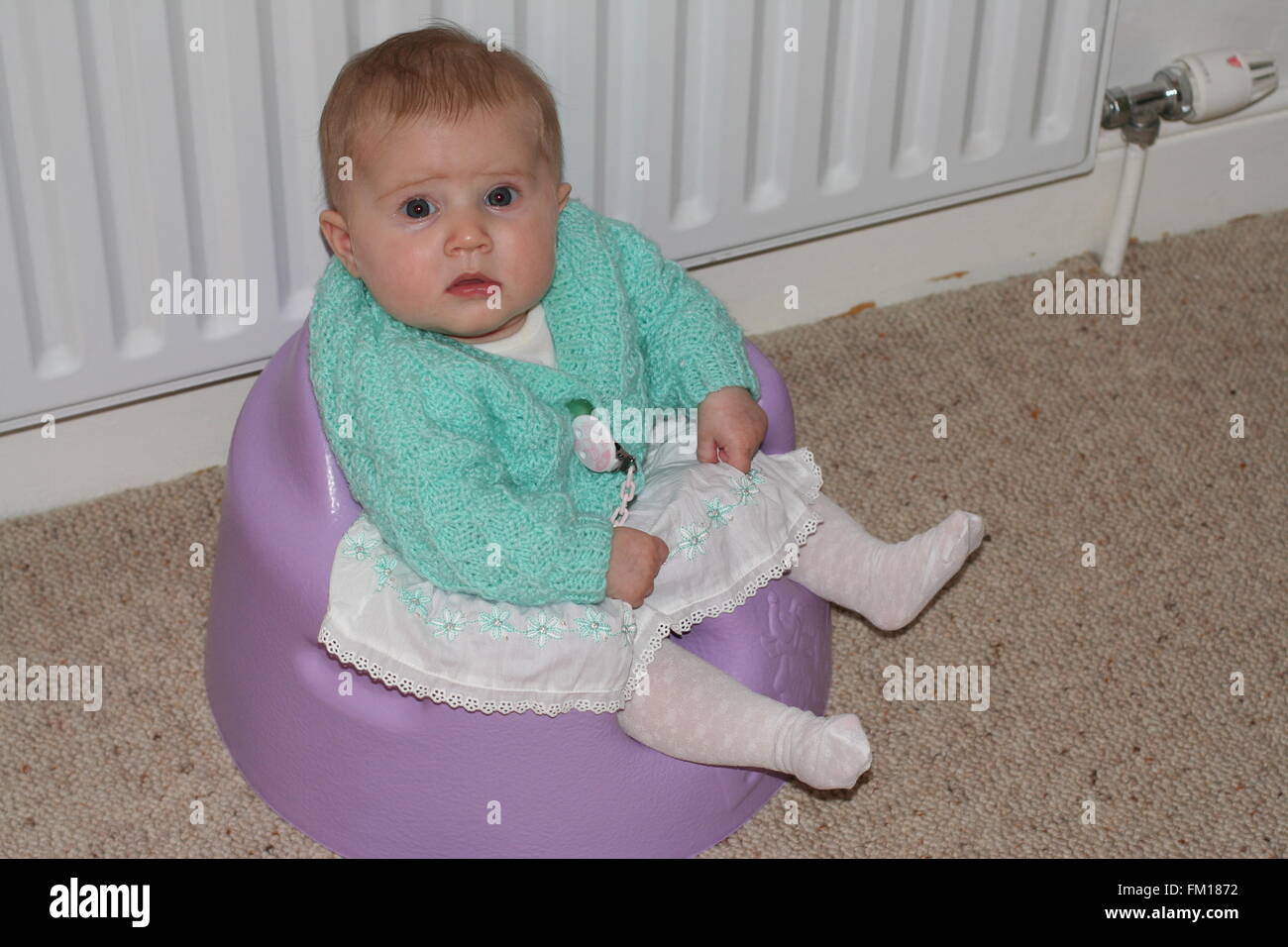 Baby girl, child chilling in her purple pod Stock Photo - Alamy
