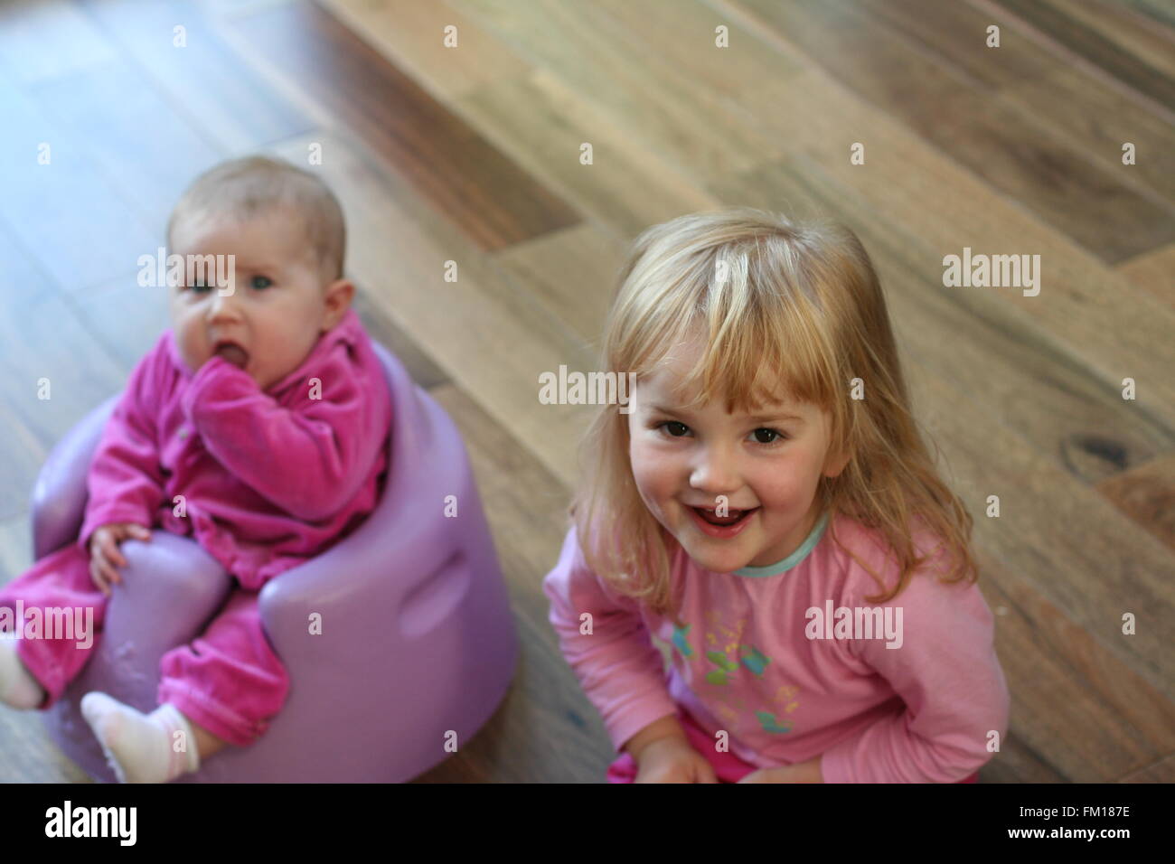 Baby girl and her big sister children, kids siblings playing together ...