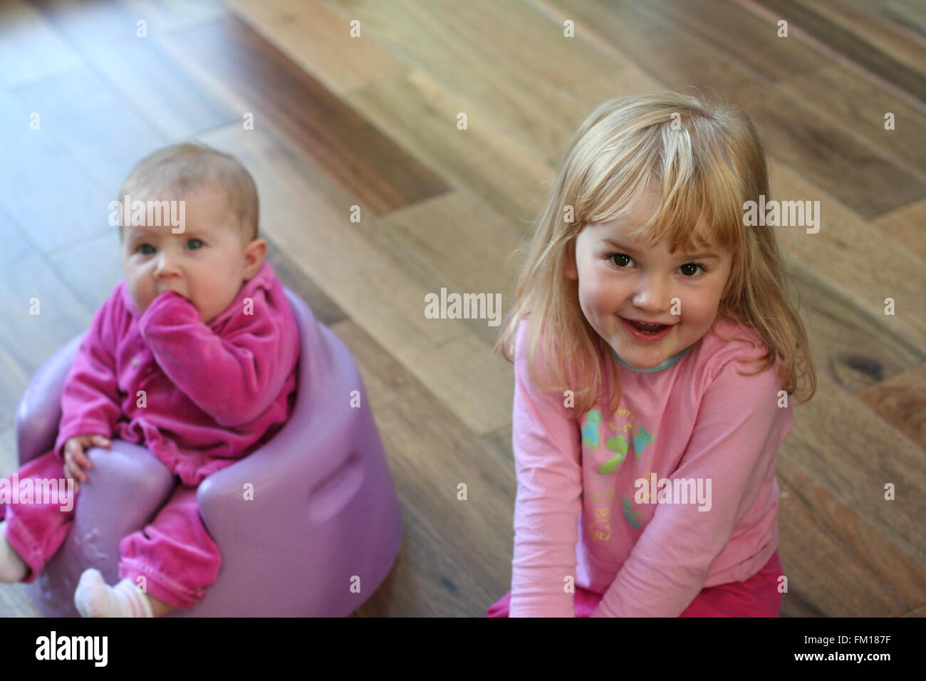 Baby girl and her big sister children, kids siblings playing together ...