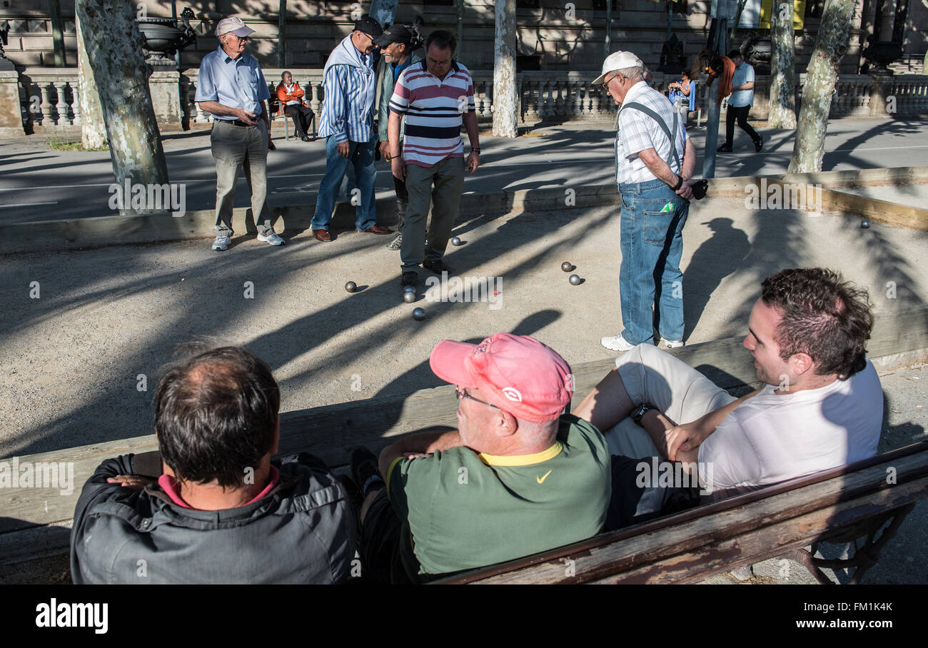 Group of men playing boules on Passeig de Lluís Companys in Sant Pere ...