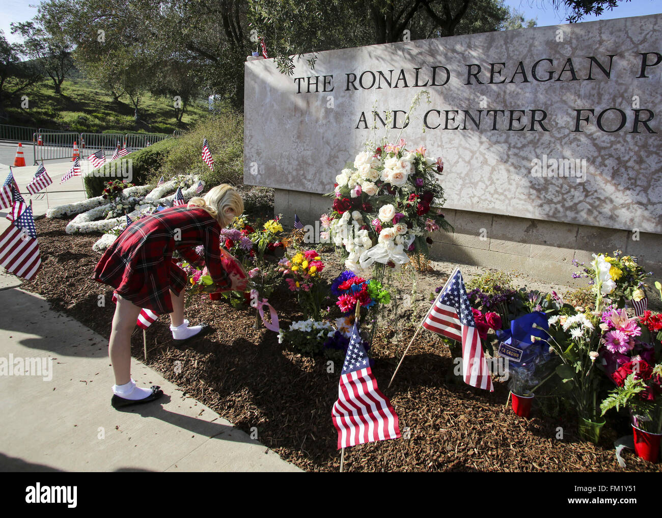 Los Angeles, California, USA. 10th Mar, 2016. People lay flowers at a ...