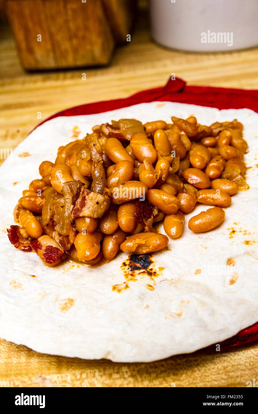 Canario beans cooked on a stove top in a stainless steal pot. Also ...