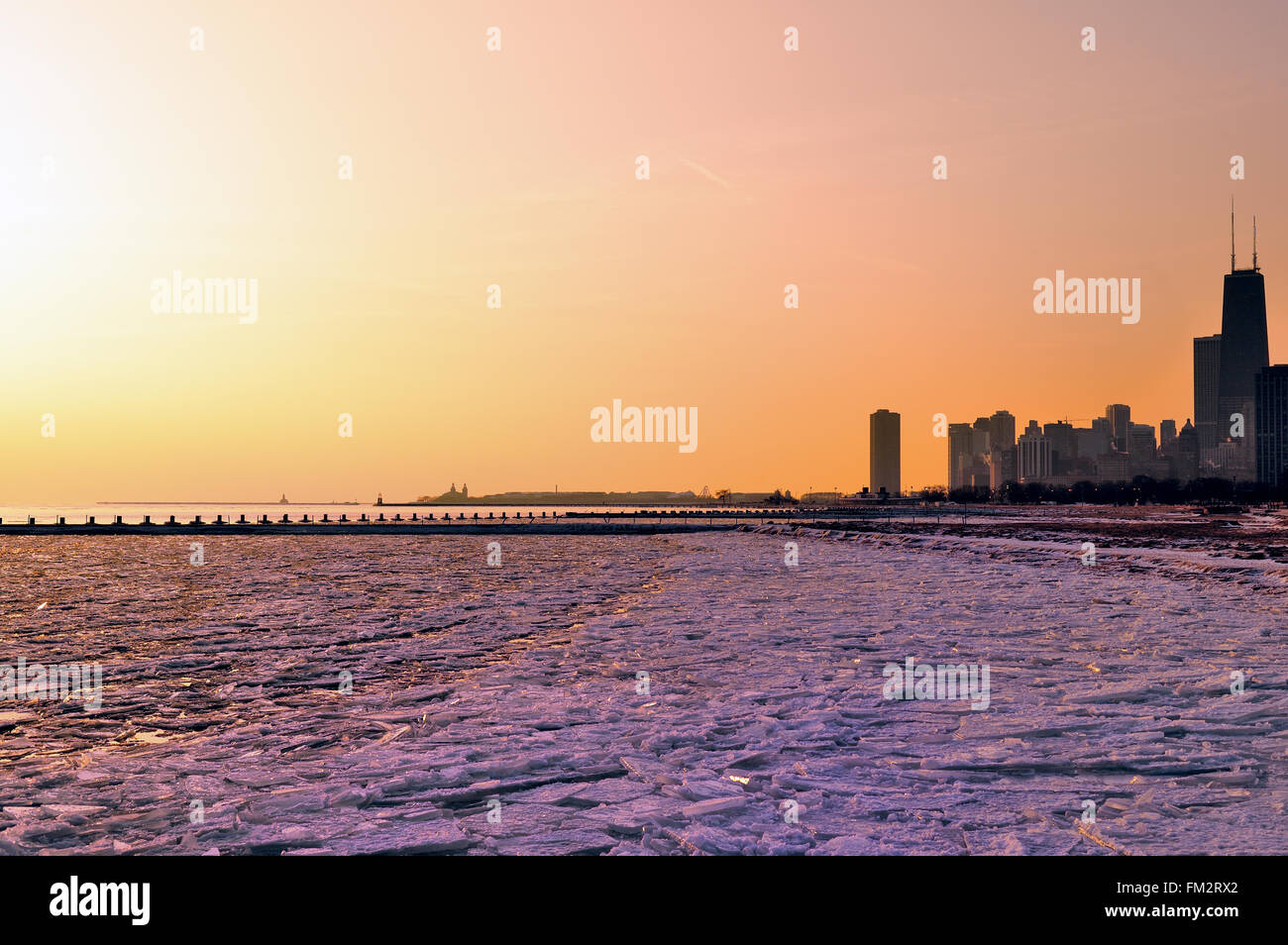Chicago, Illinois, USA. Ice clings to the waters of Lake Michigan and ...