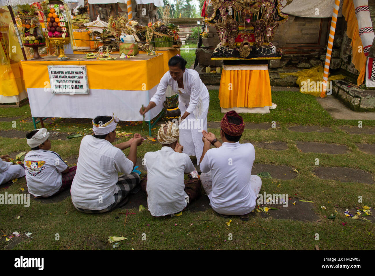 Asia, Indonesia, Bali. Hindu priestess blesses worshiper and devotee ...